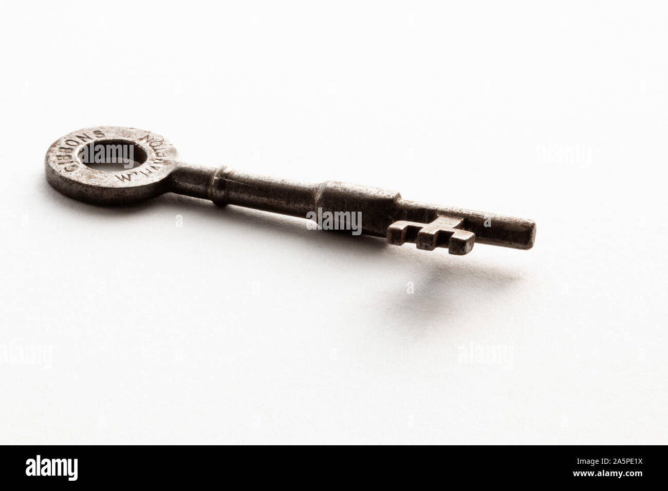 metal key on a white background Stock Photo - Alamy