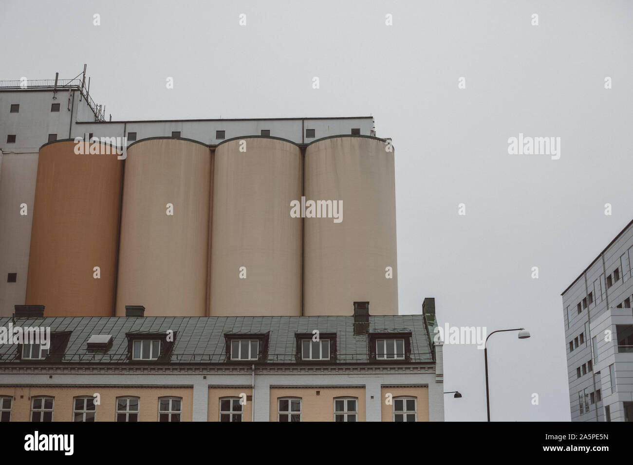 Large silo next to residential buildings Stock Photo - Alamy