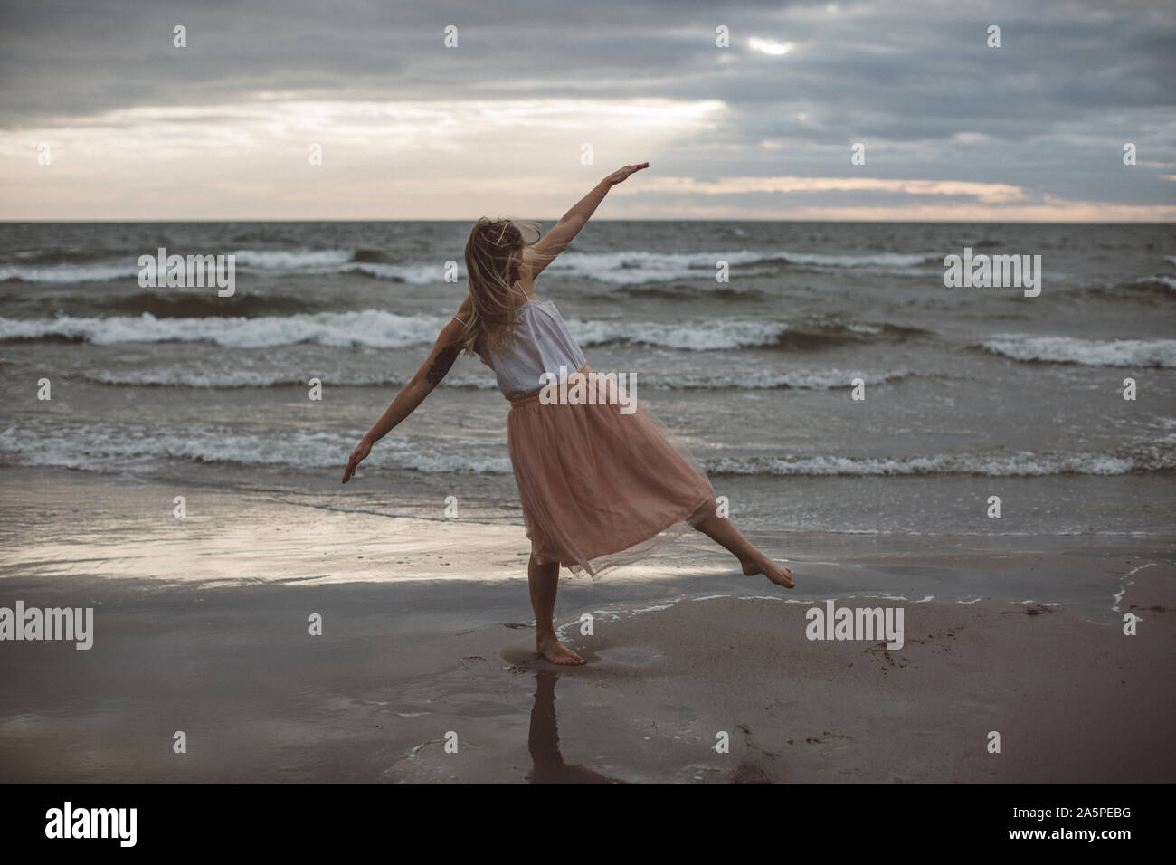 Young woman dancing on beach Stock Photo - Alamy
