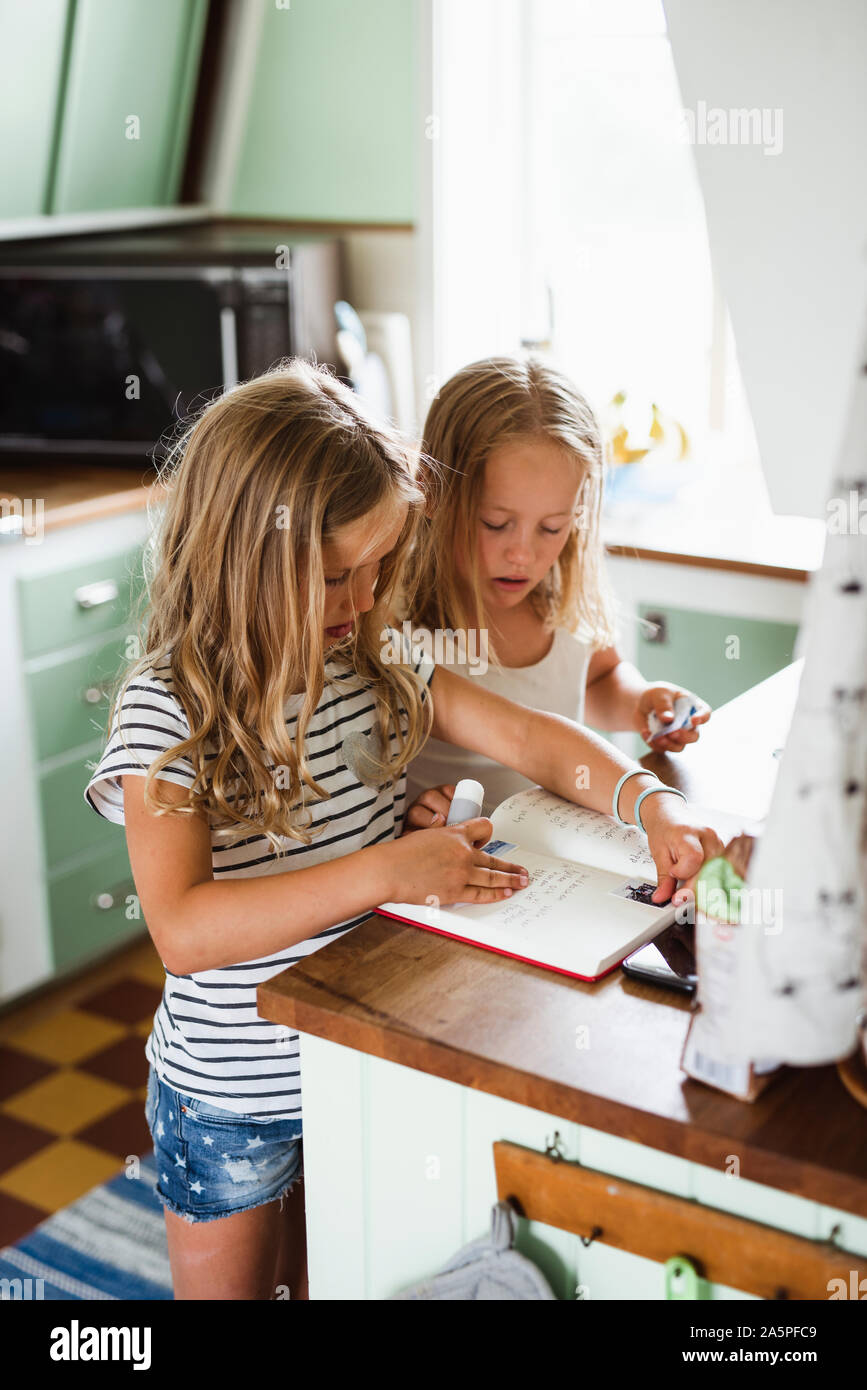Two girls with notebook Stock Photo - Alamy