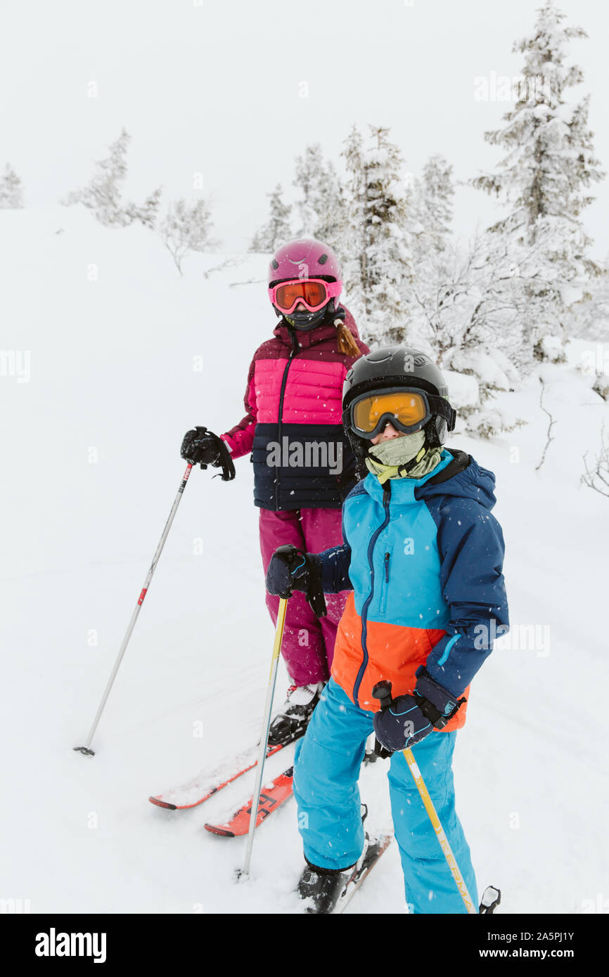 Boy and girl on ski slope Stock Photo - Alamy