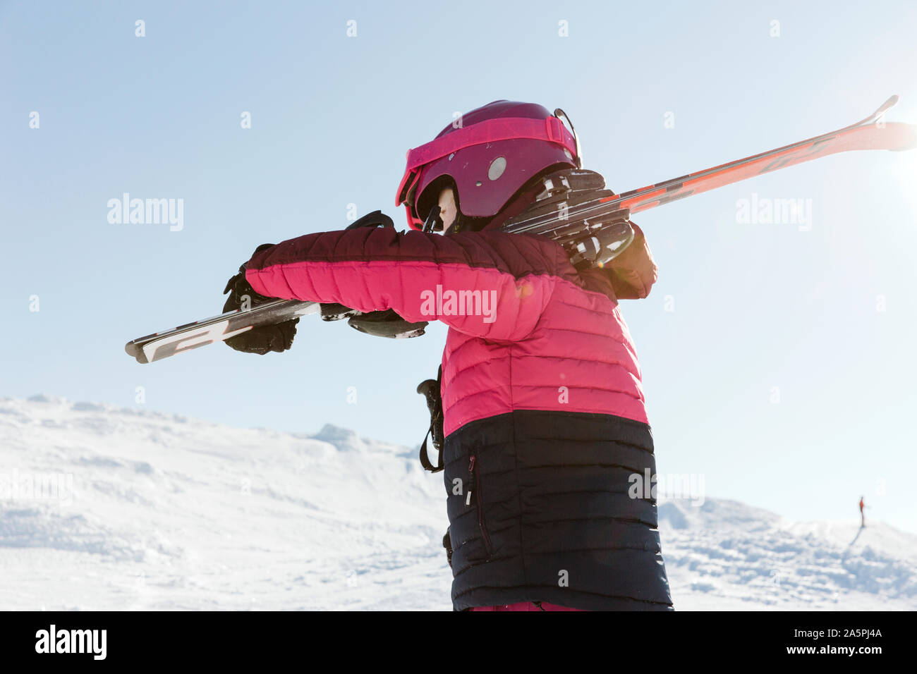 Girl carrying skis Stock Photo - Alamy
