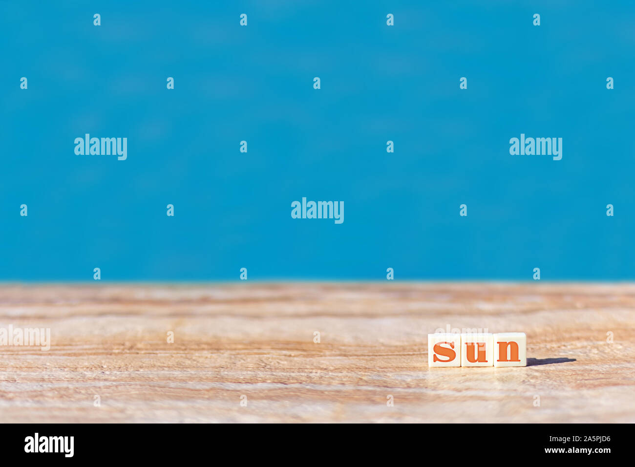 Word sun written by cubes near the pool. Azure water in sunny day used ...