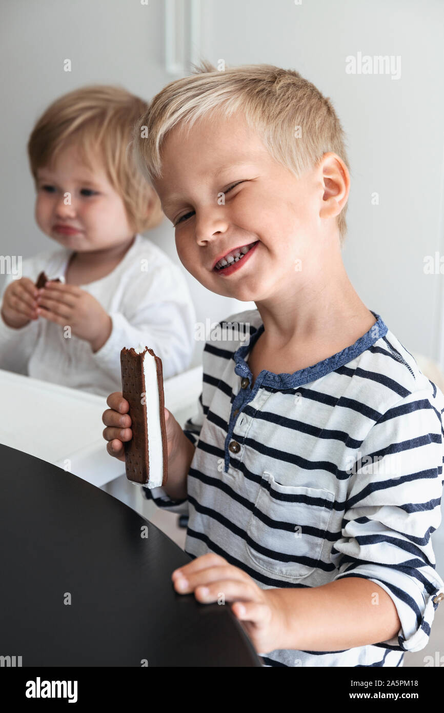 Boy eating biscuit hi-res stock photography and images - Alamy