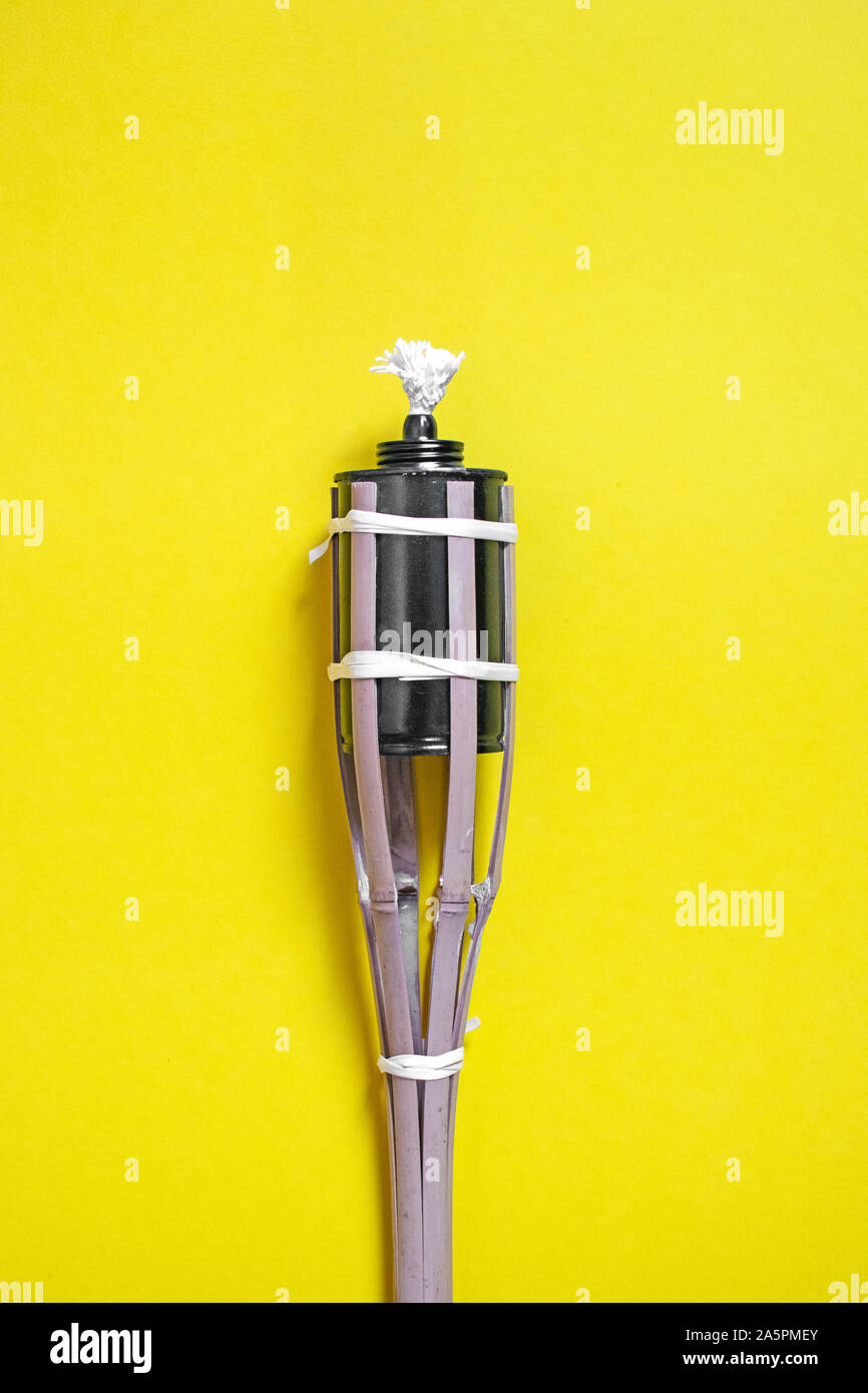 A close up of bamboo fire torch on yellow background Stock Photo - Alamy