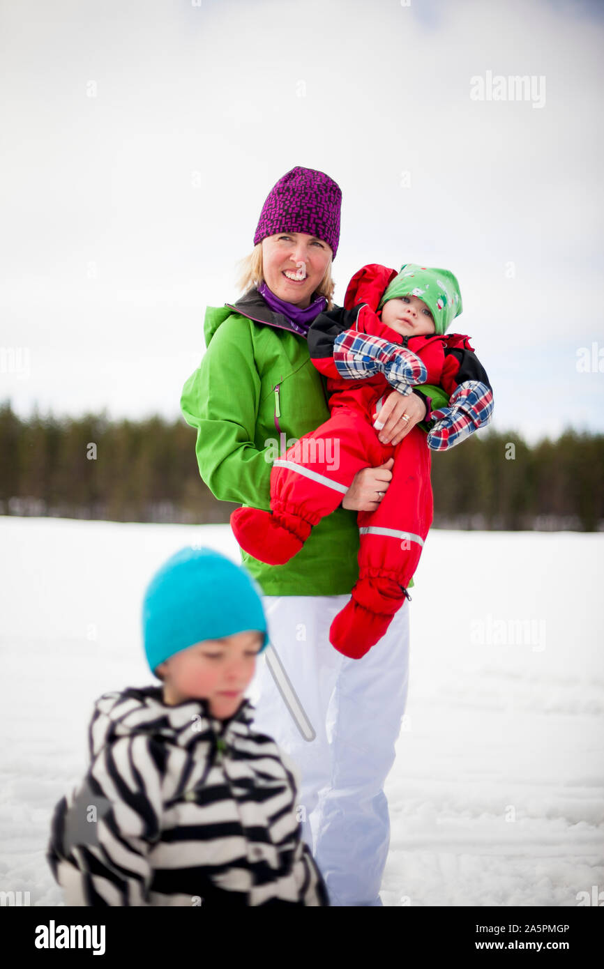 Mother with kids at winter Stock Photo - Alamy