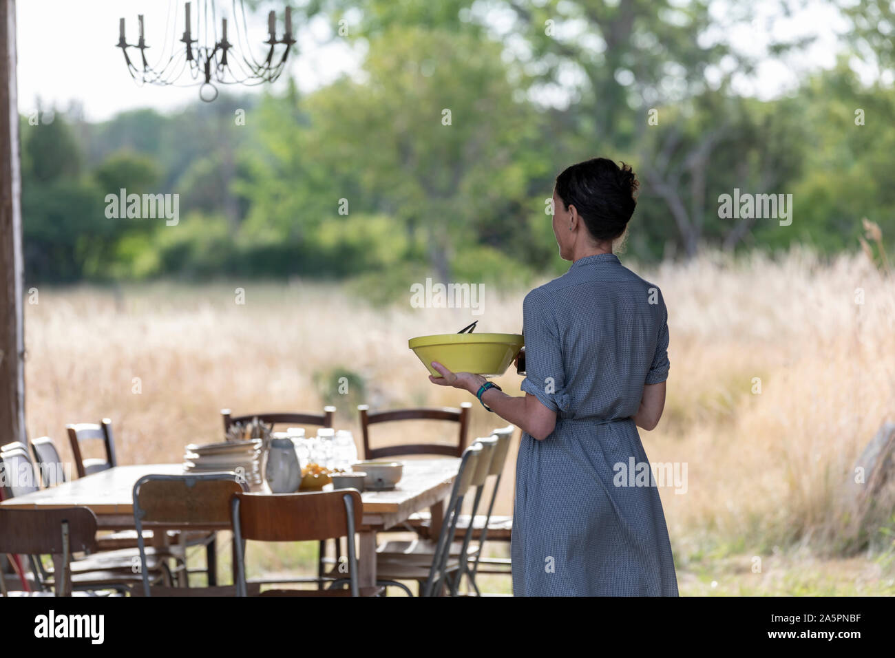 Woman setting table Stock Photo - Alamy
