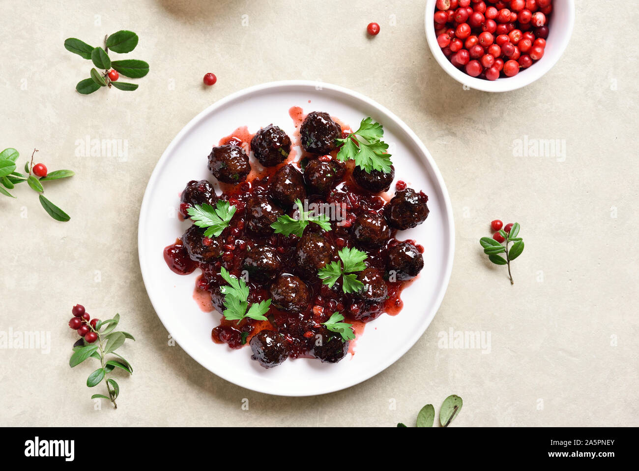 Delicious meatballs with cranberry sauce on white plate over light ...