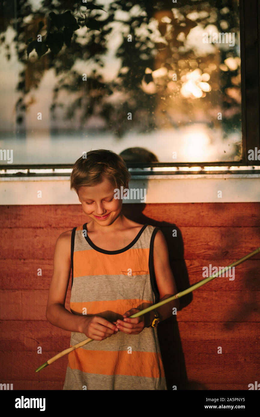 Boy holding stick Stock Photo - Alamy