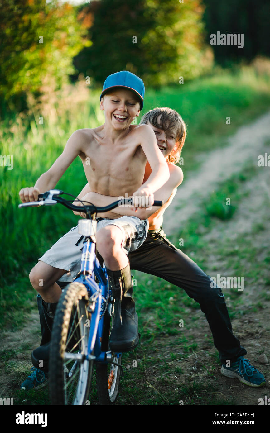 Happy boys cycling Stock Photo - Alamy