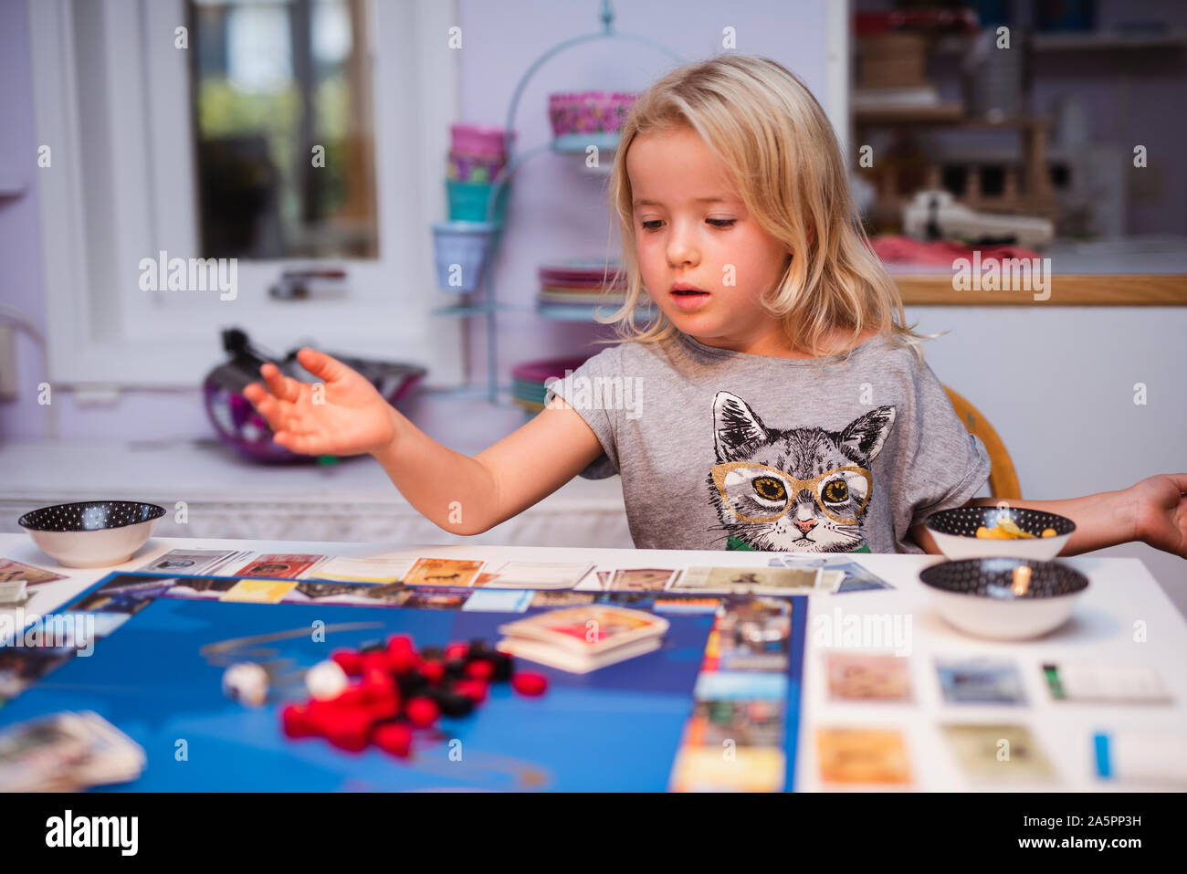 Girl playing board game Stock Photo - Alamy