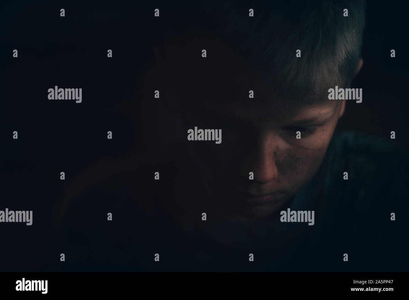 Boy in dark room Stock Photo - Alamy