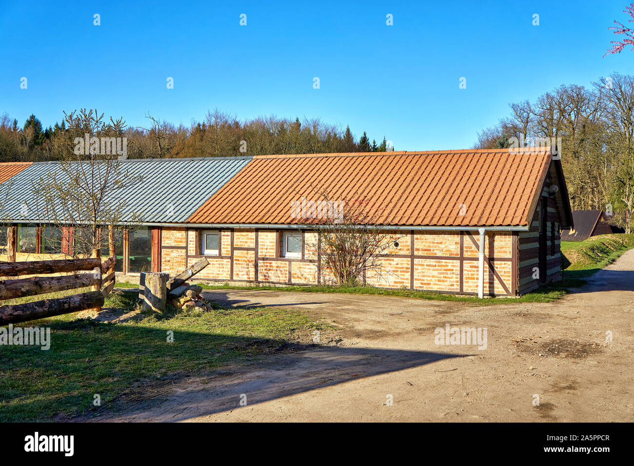 Small long half-timbered house with red tiled roof Stock Photo - Alamy