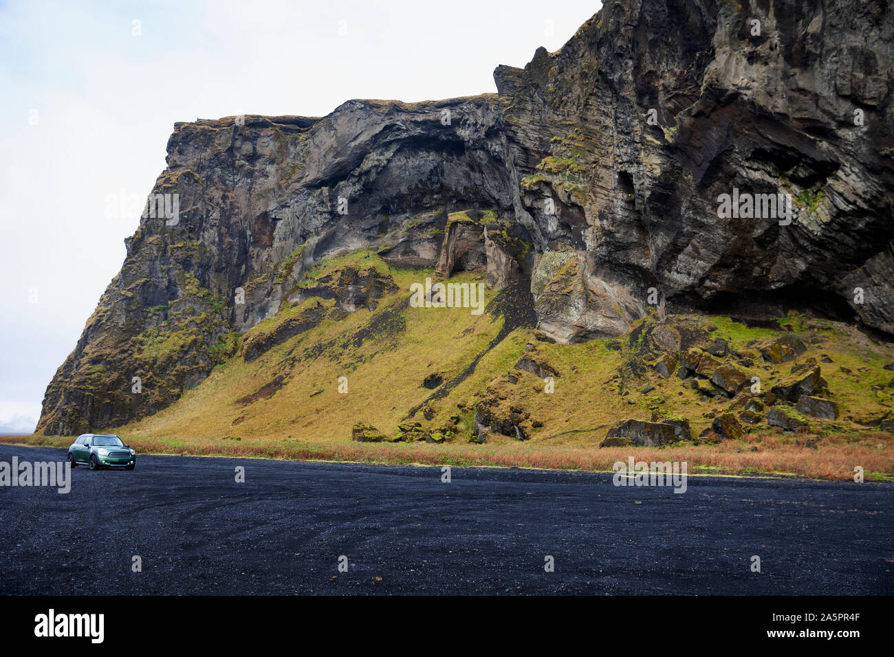 Small car next to large cliffs Stock Photo - Alamy
