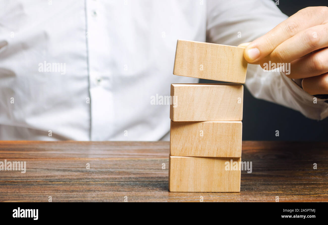 Businessman puts wooden blocks. Business management concept. Planning ...