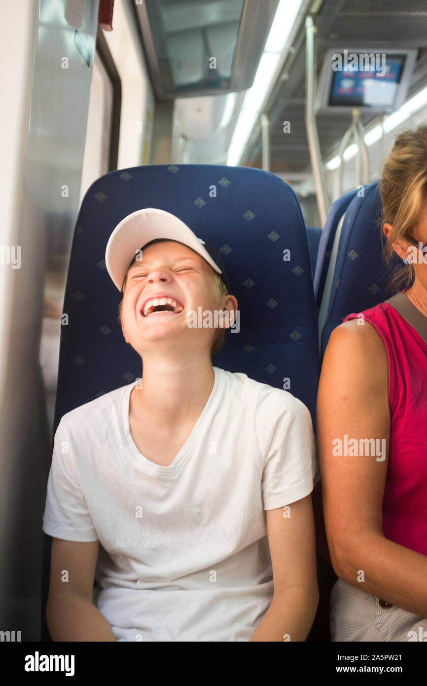 Boy laughing on train Stock Photo - Alamy
