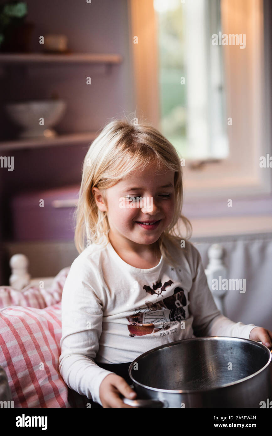 Girl playing with pot Stock Photo - Alamy