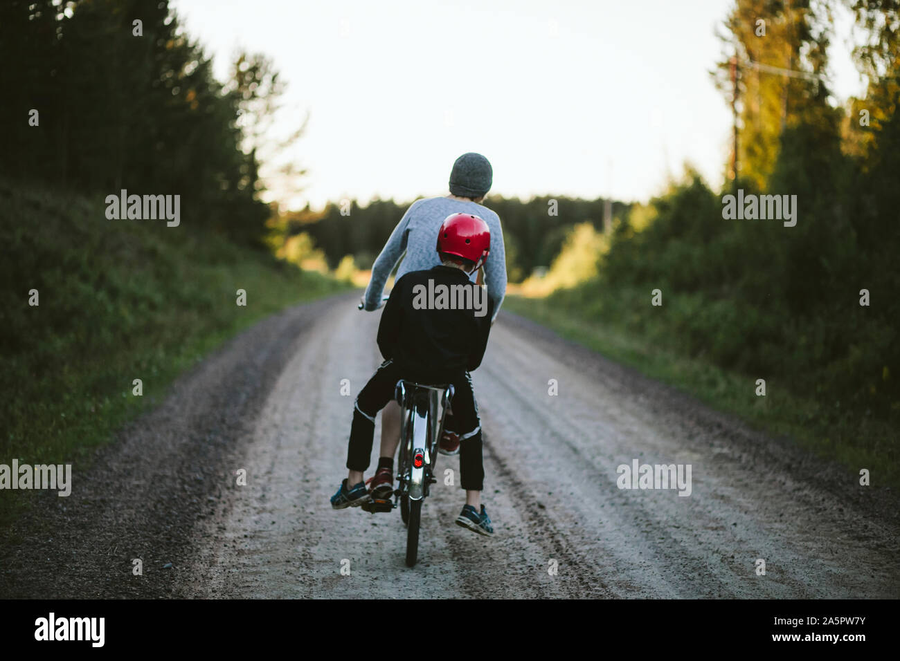 Two boys riding bicycle hi-res stock photography and images - Alamy