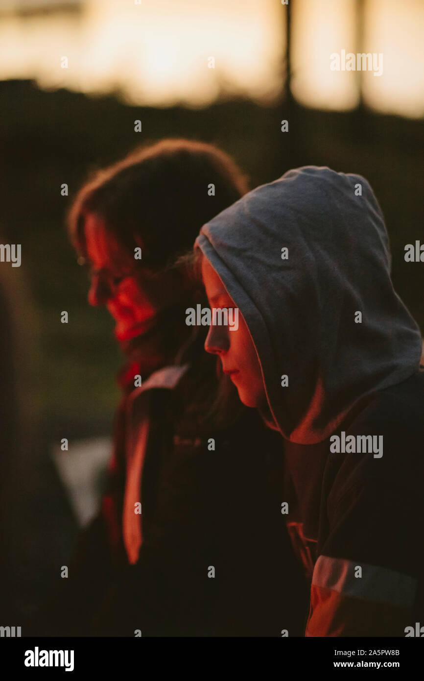 Woman and boy looking at fire Stock Photo - Alamy