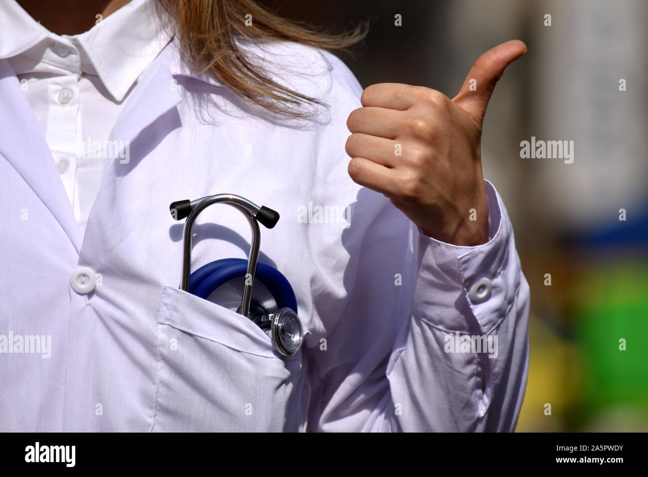 Female Medical Professional With Thumbs Up Wearing Lab Coat Stock Photo ...