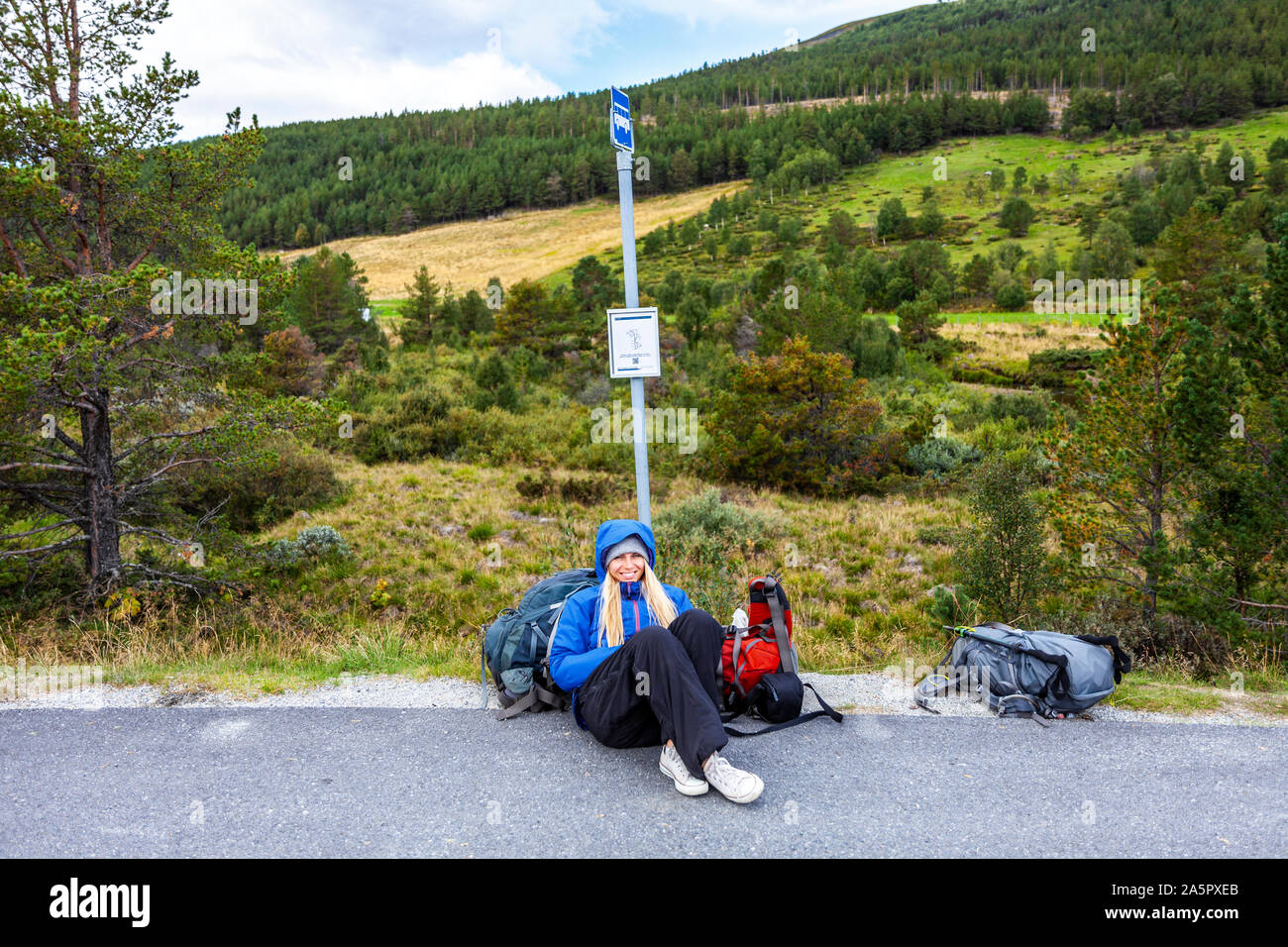Woman on bus stop Stock Photo - Alamy
