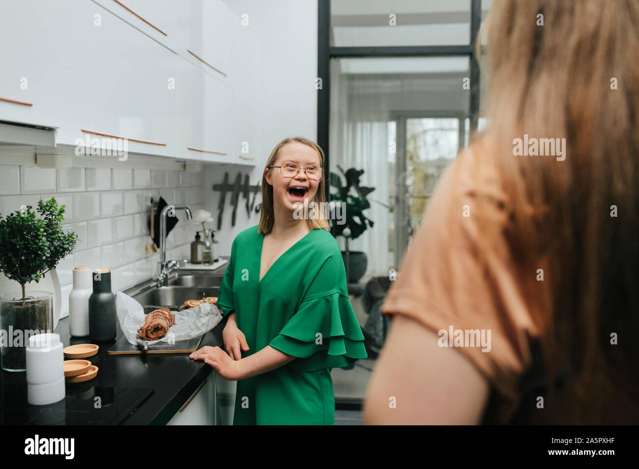 Happy teenage girl in kitchen Stock Photo - Alamy