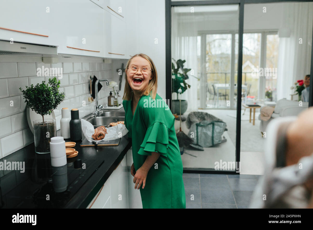 Happy teenage girl in kitchen Stock Photo - Alamy