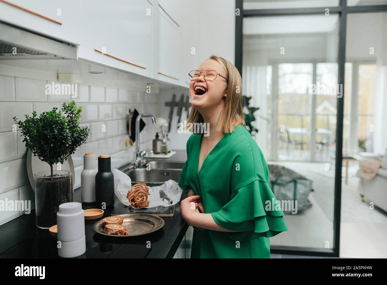 Happy teenage girl in kitchen Stock Photo - Alamy