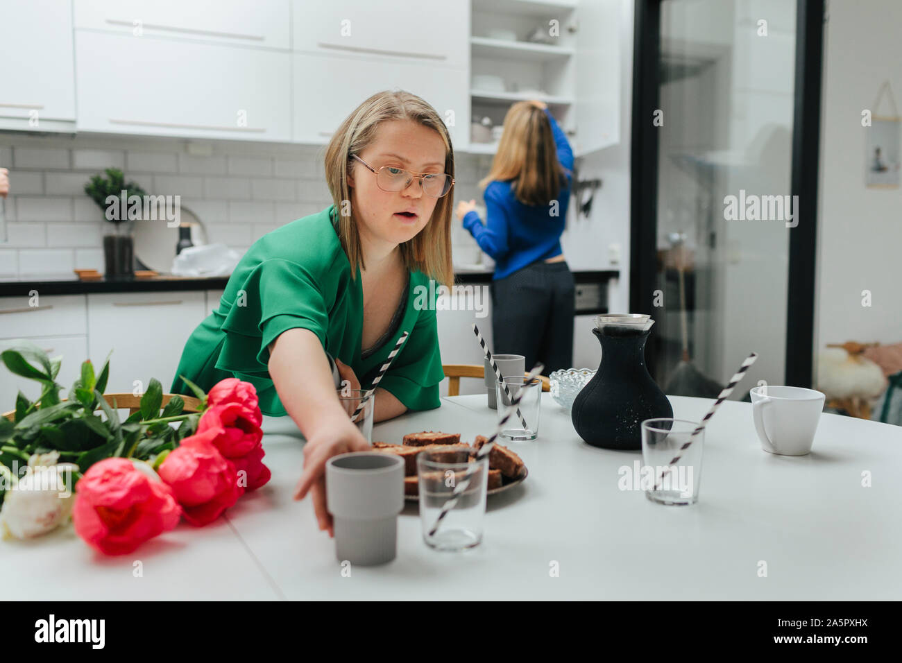 Teenage girl preparing table Stock Photo - Alamy