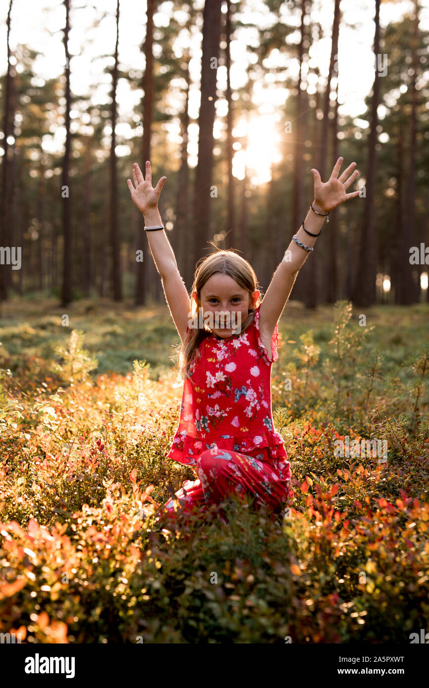 Girl with arms raised Stock Photo - Alamy