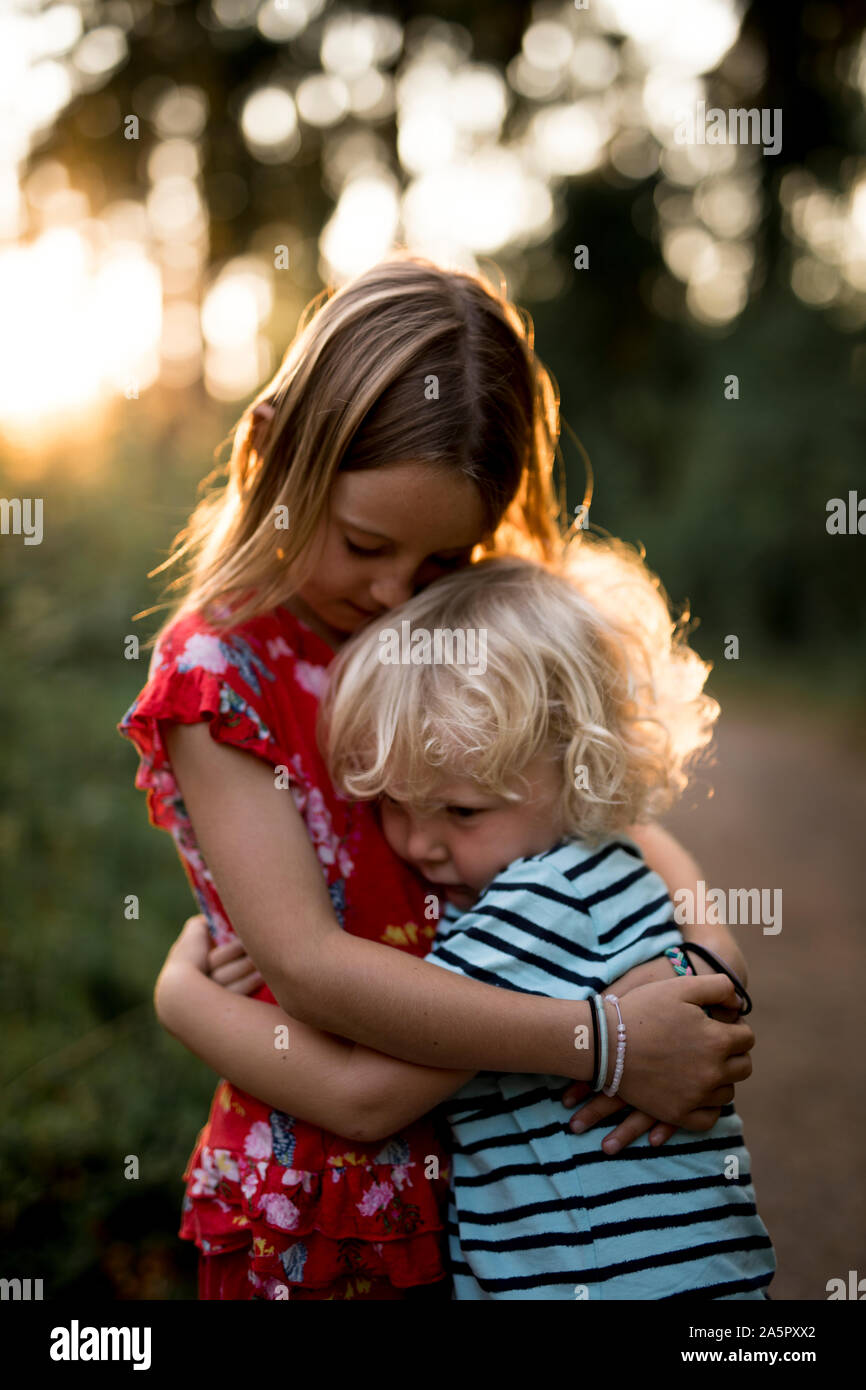 Brother and sister hugging Stock Photo - Alamy