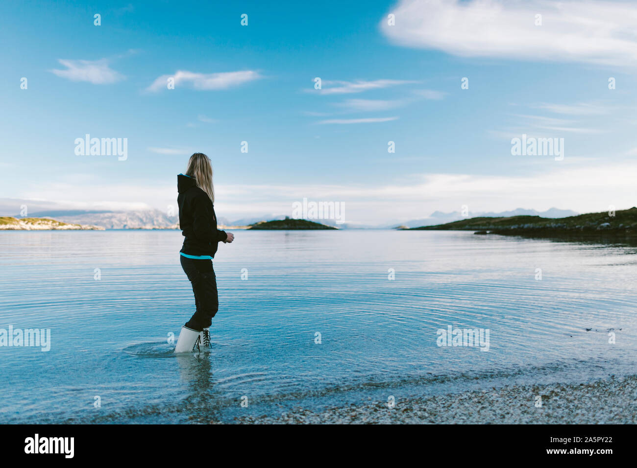 Woman standing in water Stock Photo - Alamy