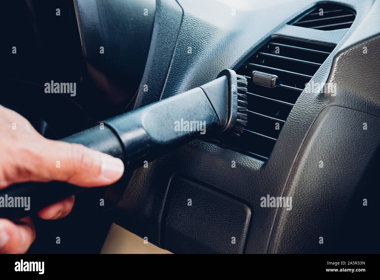 Worker man cleaning dust interior vacuum inside car after wash Stock ...