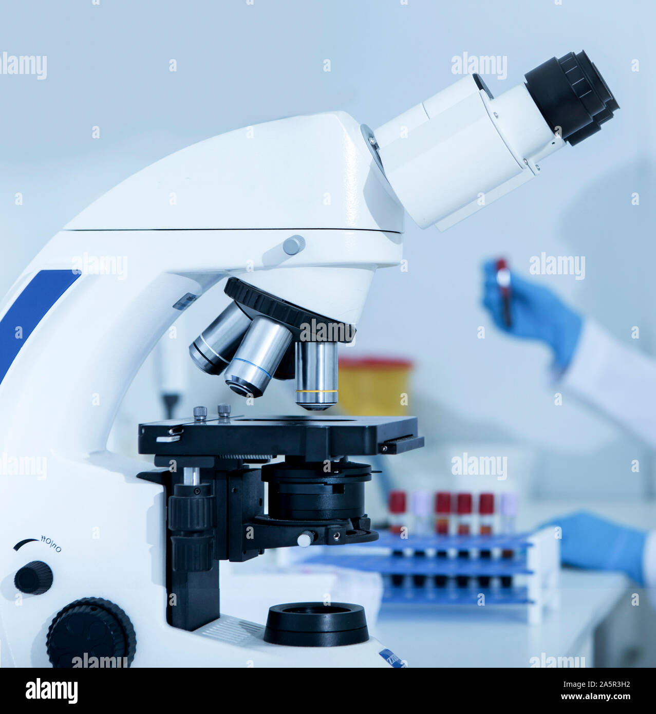 Scientist examining samples microscope hi-res stock photography and ...