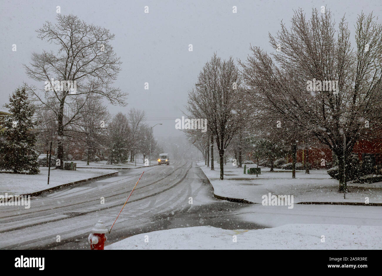 Winter landscape street of a small town snow covered pavement USA ...