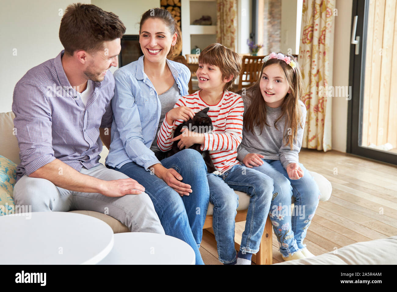 Harmonious family in living room hi-res stock photography and images ...