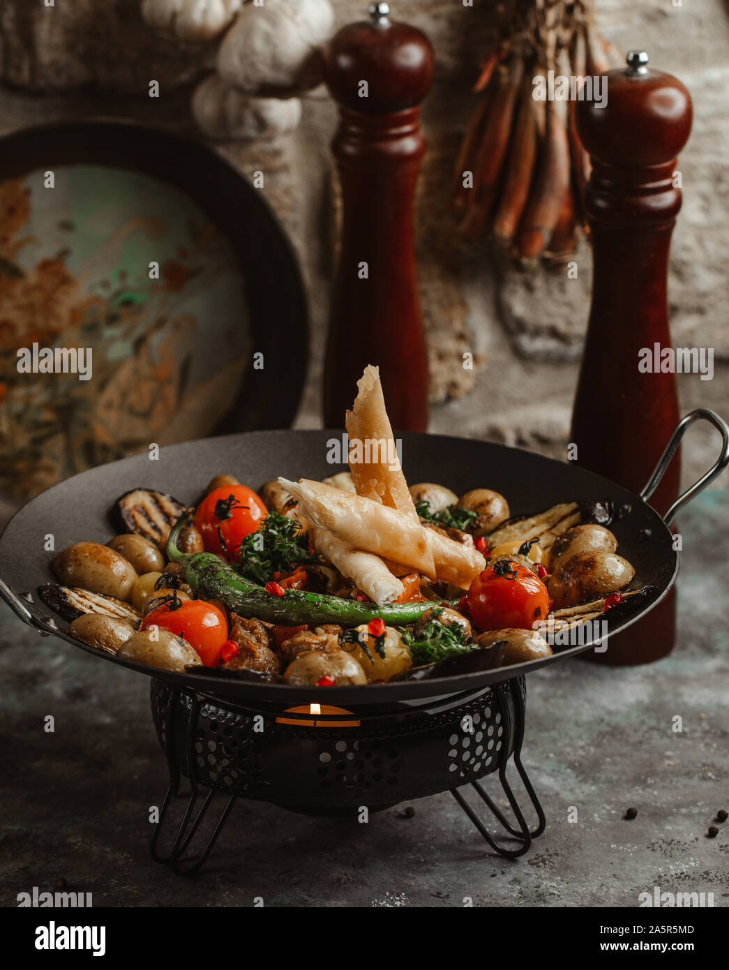 azerbaijani chicken saj with tomato, potato, pepper, aubergine and ...