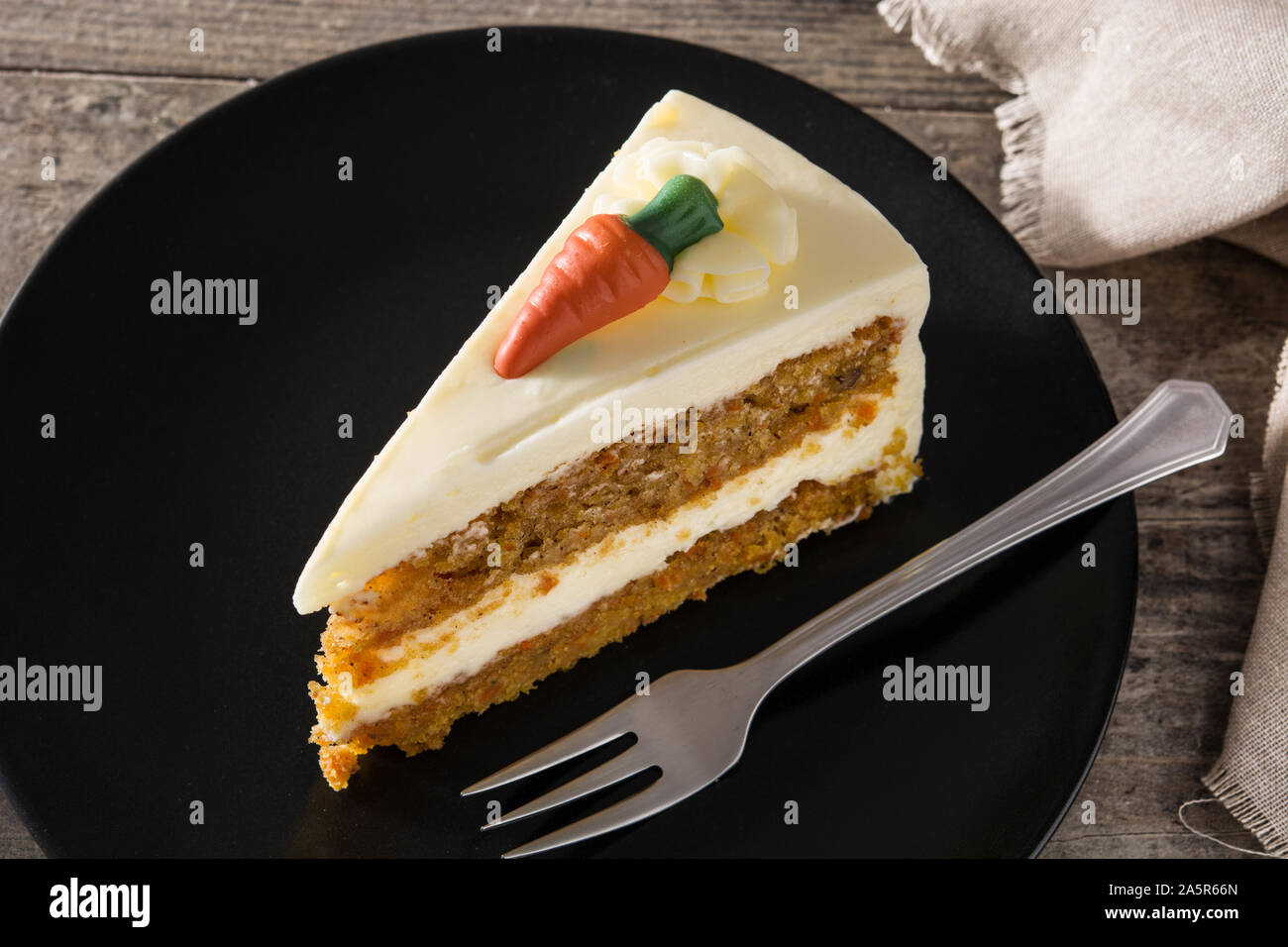 Sweet carrot cake slice on a plate on wooden table Stock Photo - Alamy