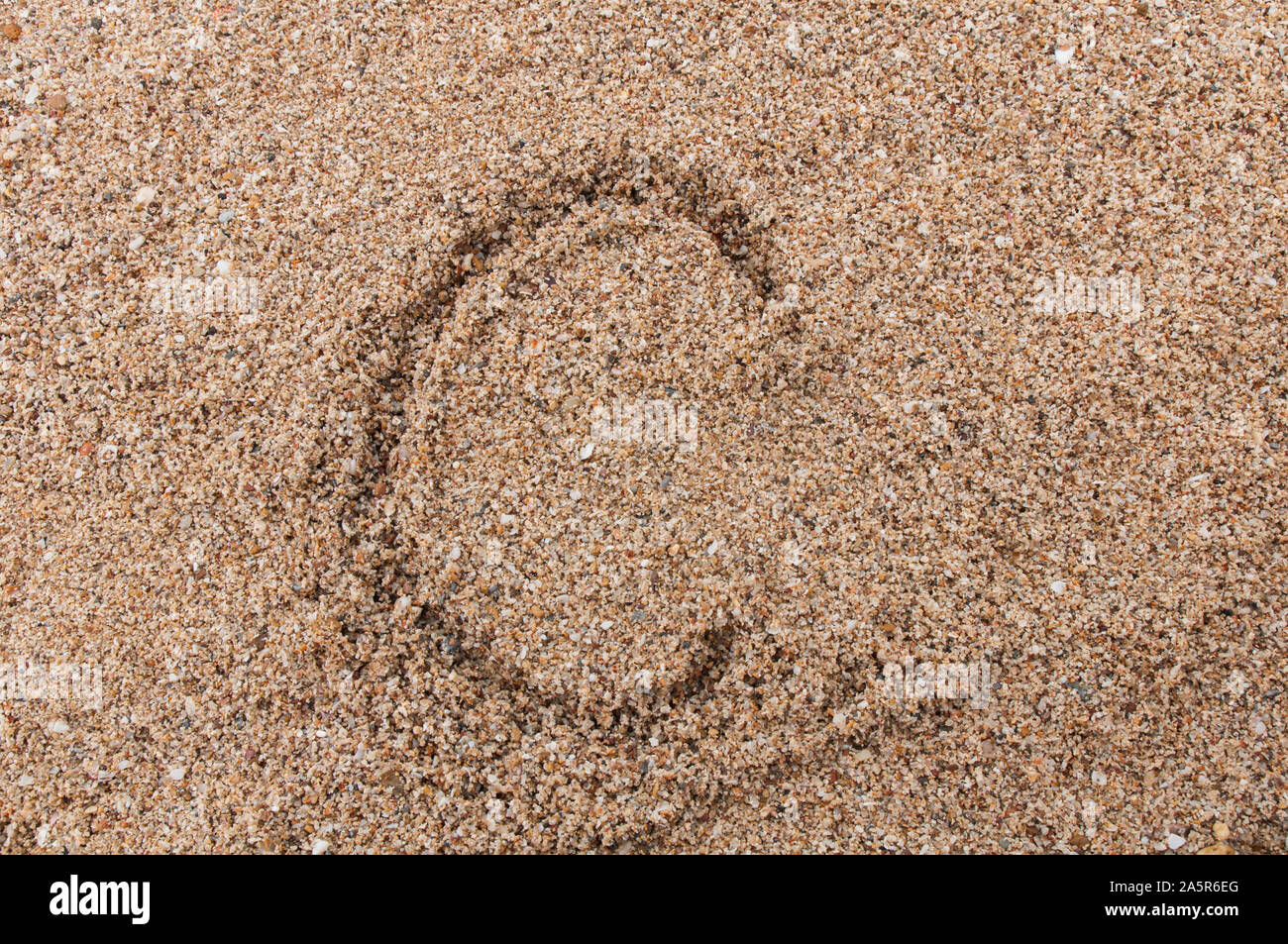 Character C of the alphabet writing on the sand Stock Photo - Alamy