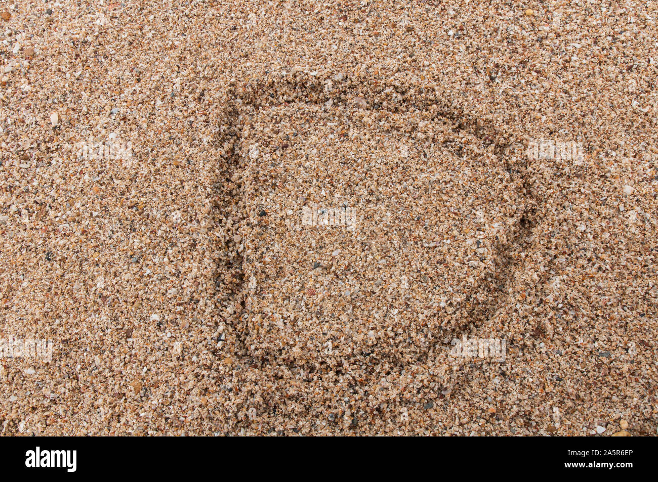 Character D of the alphabet writing on the sand Stock Photo - Alamy