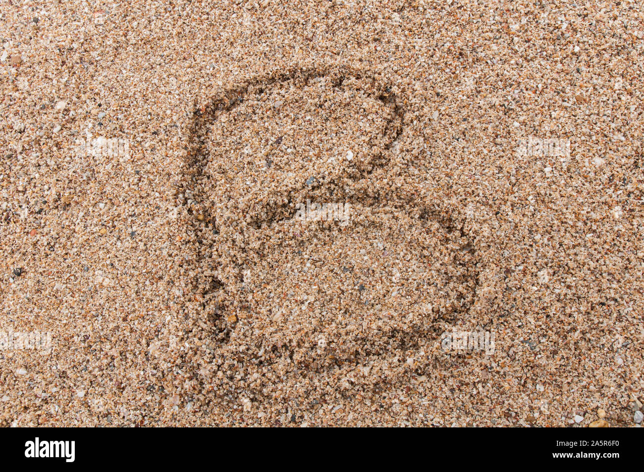 Character B of the alphabet writing on the sand Stock Photo - Alamy