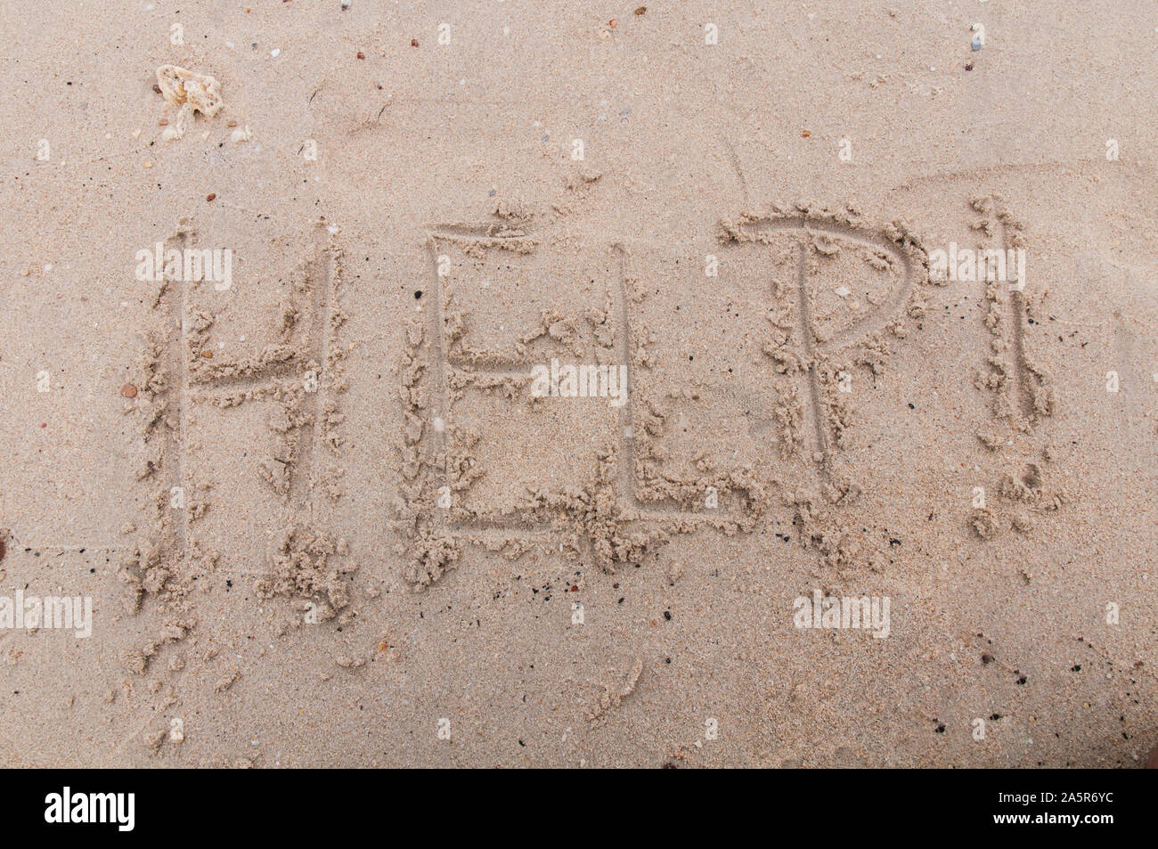 Help sign on sand tropical hi-res stock photography and images - Alamy