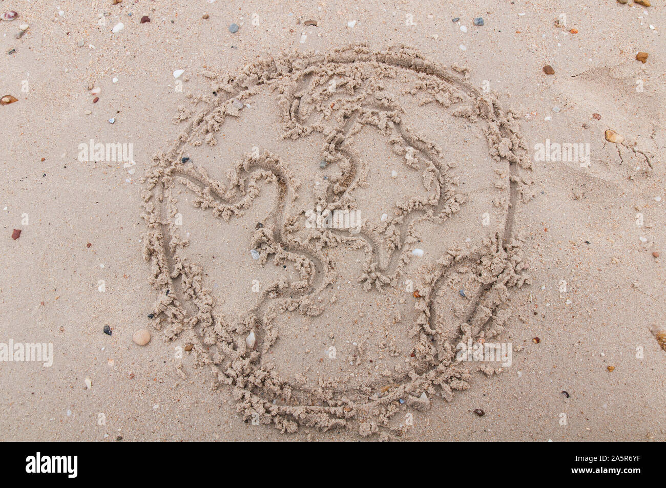 The word world handwritten in sand on a beach Stock Photo - Alamy