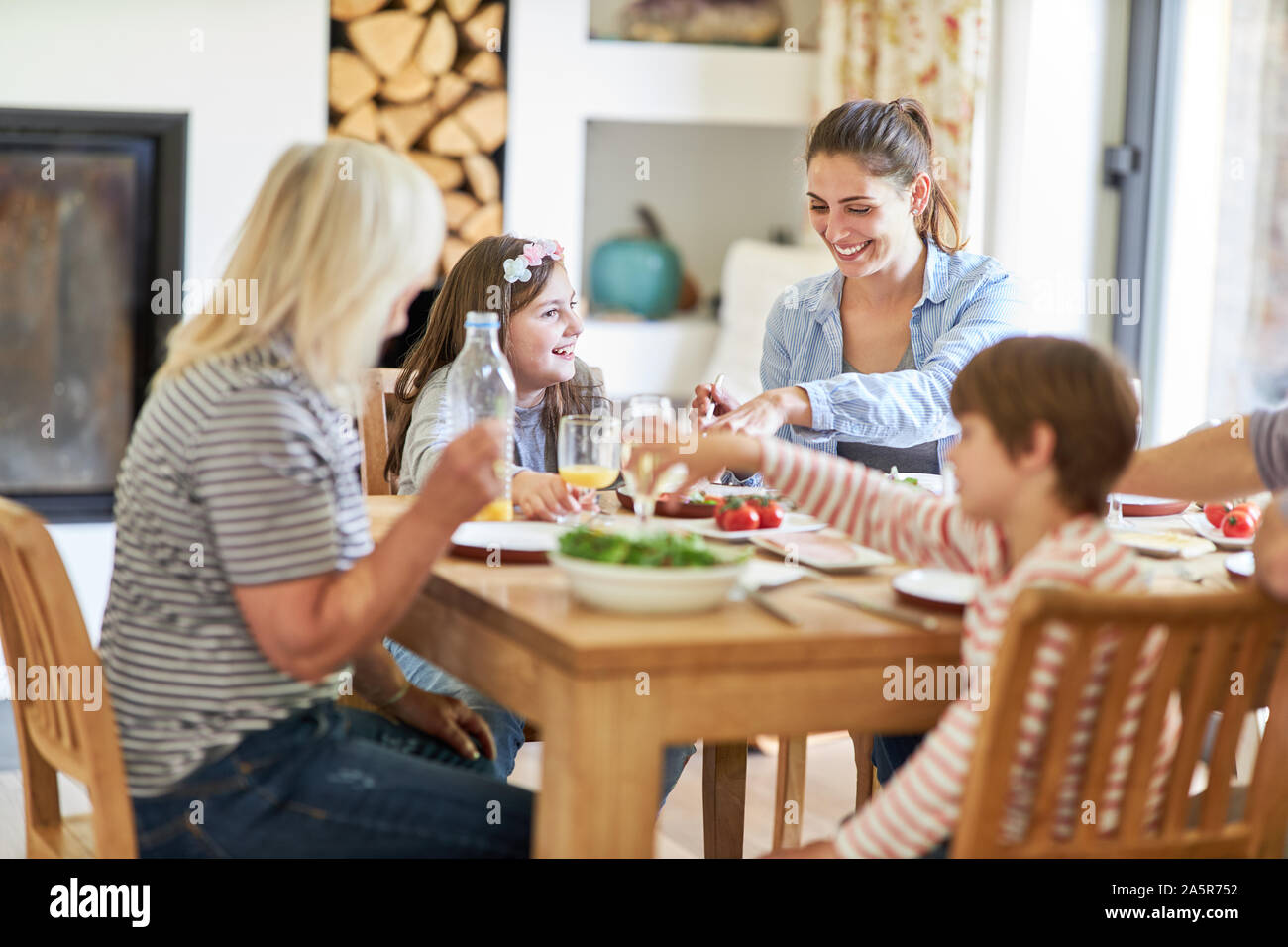 Mother with children and grandma having lunch or dinner at the dining ...