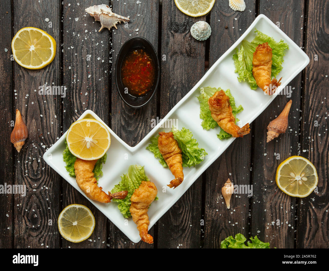 crispy fried tiger prawns served with lemon and sweet chili sauce Stock ...