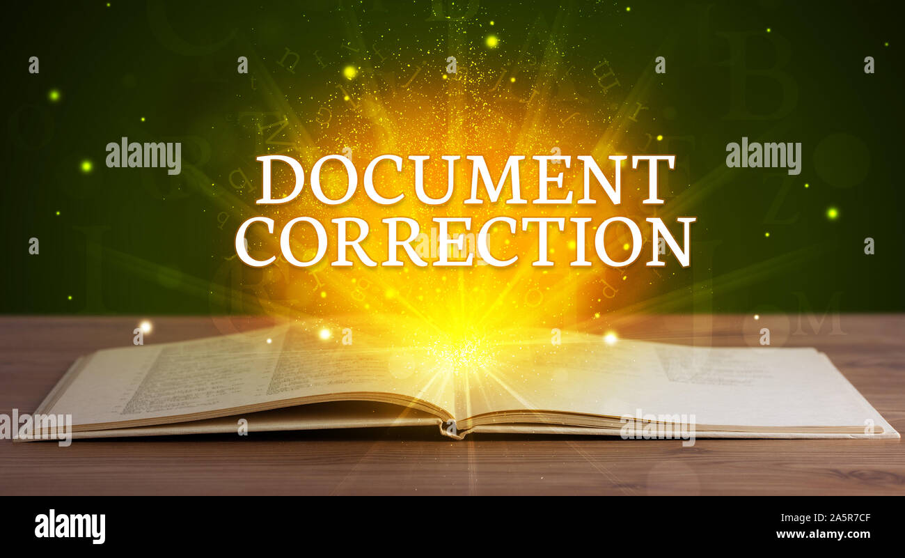 DOCUMENT CORRECTION inscription coming out from an open book ...