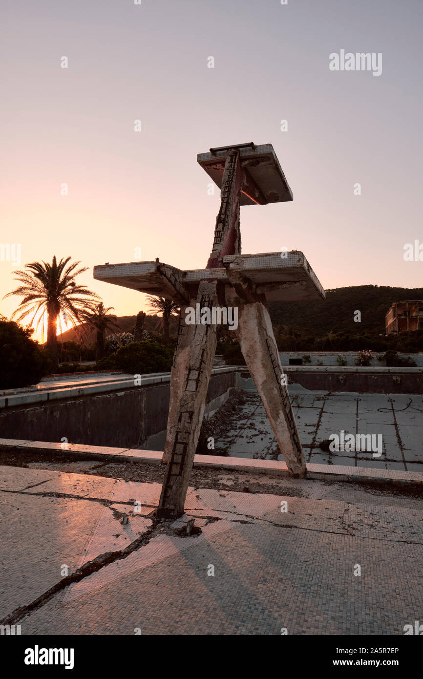 The abandoned Funtanazza hotel complex swimming pool diving board, a ...