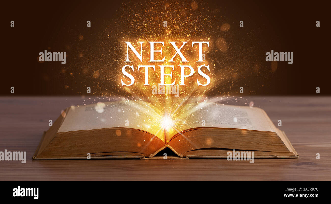 NEXT STEPS inscription coming out from an open book, educational ...