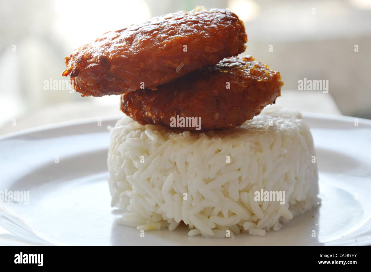 deep fried chop pork overlay on plain rice Stock Photo - Alamy