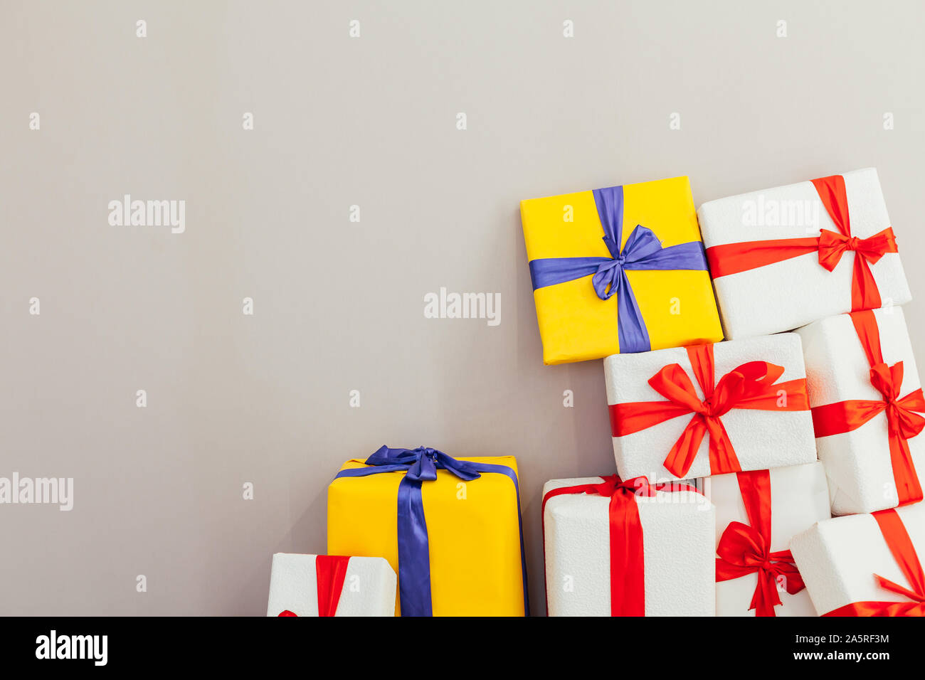 birthday presents on a grey background holliday Stock Photo - Alamy